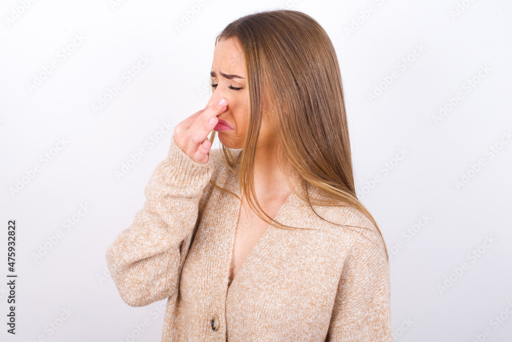 young caucasian girl wearing knitted sweater over white background ...