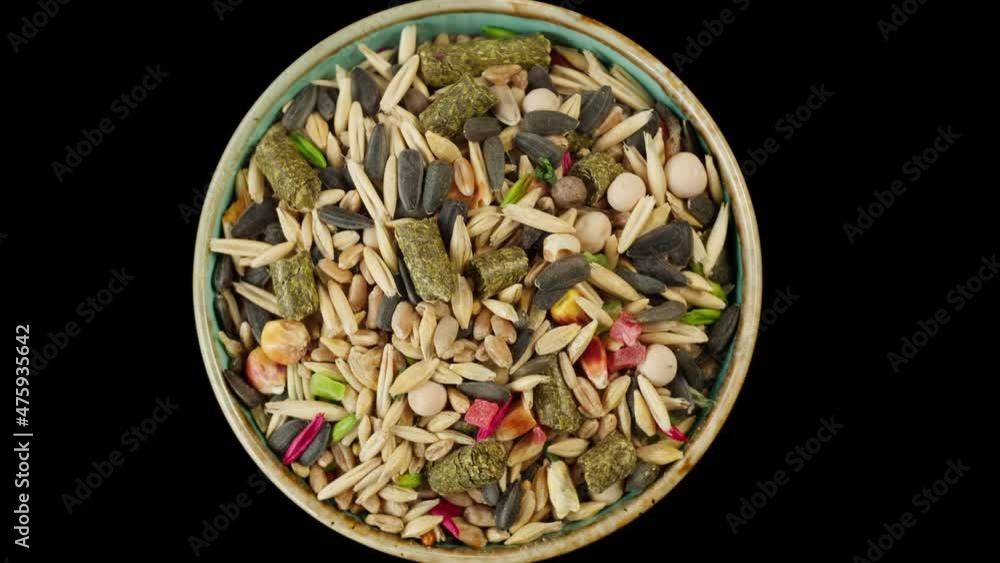 Video „Rodents food in bowl close-up rotating. Granules mixture in dish ...