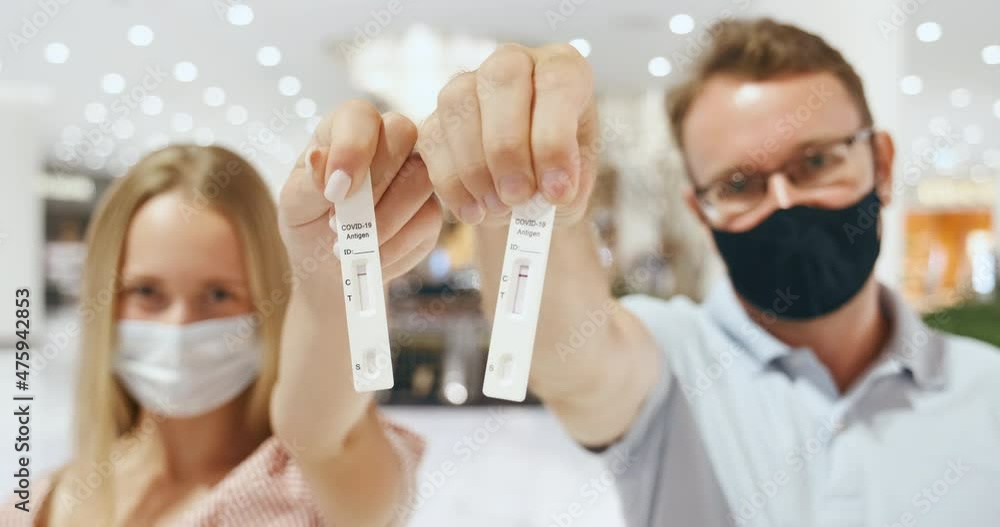 Couple man and woman show their negative COVID-19 antigen test results ...