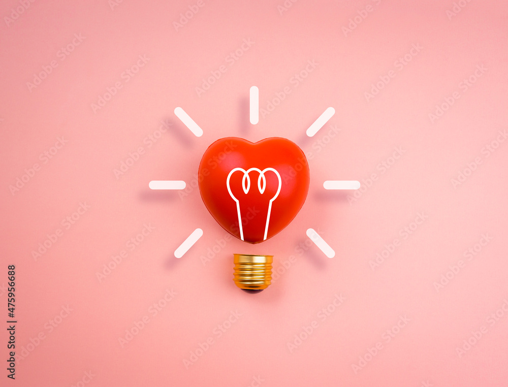 Light bulb icon on red heart ball on pink pastel background, minimal ...