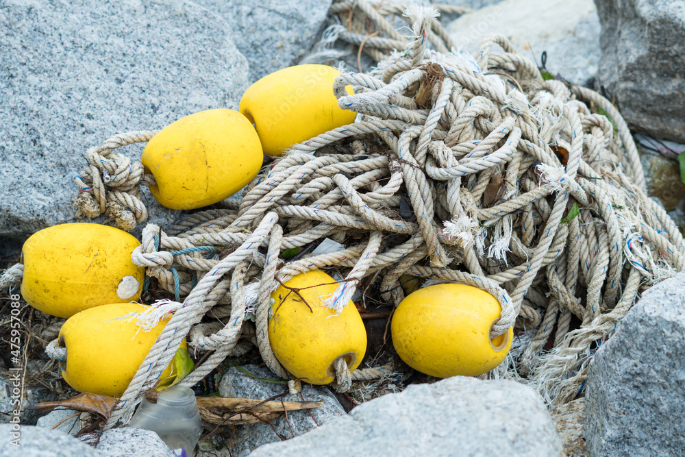 Close up view of old fishing net washed ashore on the beach. Old rope ...