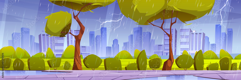 City park with green lawn, bushes, trees and stone walkway in rain ...