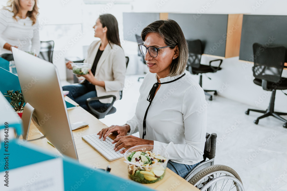 Latin transgender woman working with computer at the office in Mexico ...