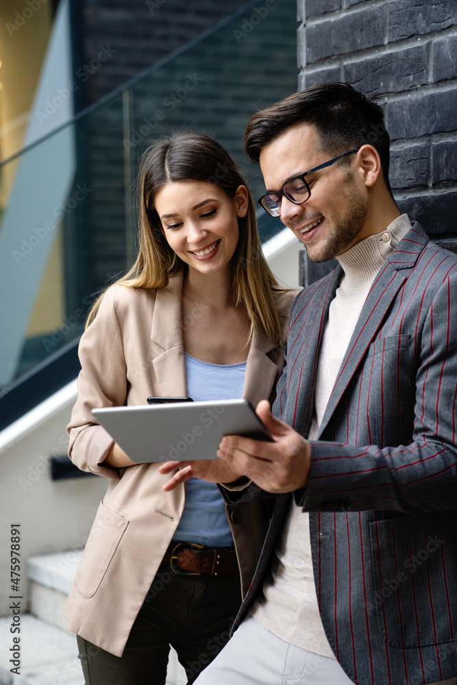 Successful young business people talking, working together in front of ...