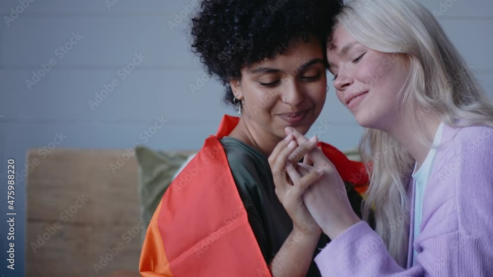 Video „young Lesbian Couple Kisses Holding Hands Sitting On A Couch