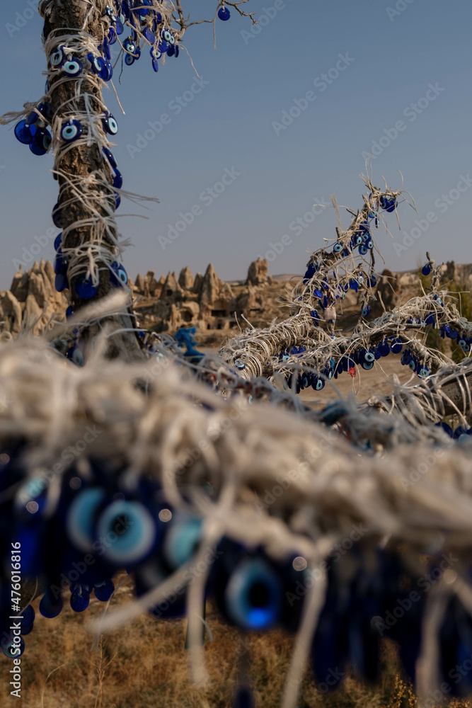 Eerie scenery of evil eye superstitious symbols on tree in Cappadocia ...