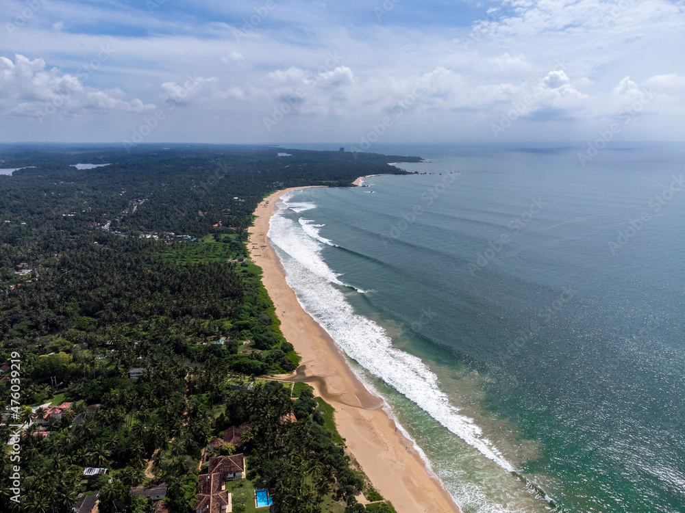 Sri Lanka. Ahungalla beach: ocean, coastal waves, sand. Tropical trees ...