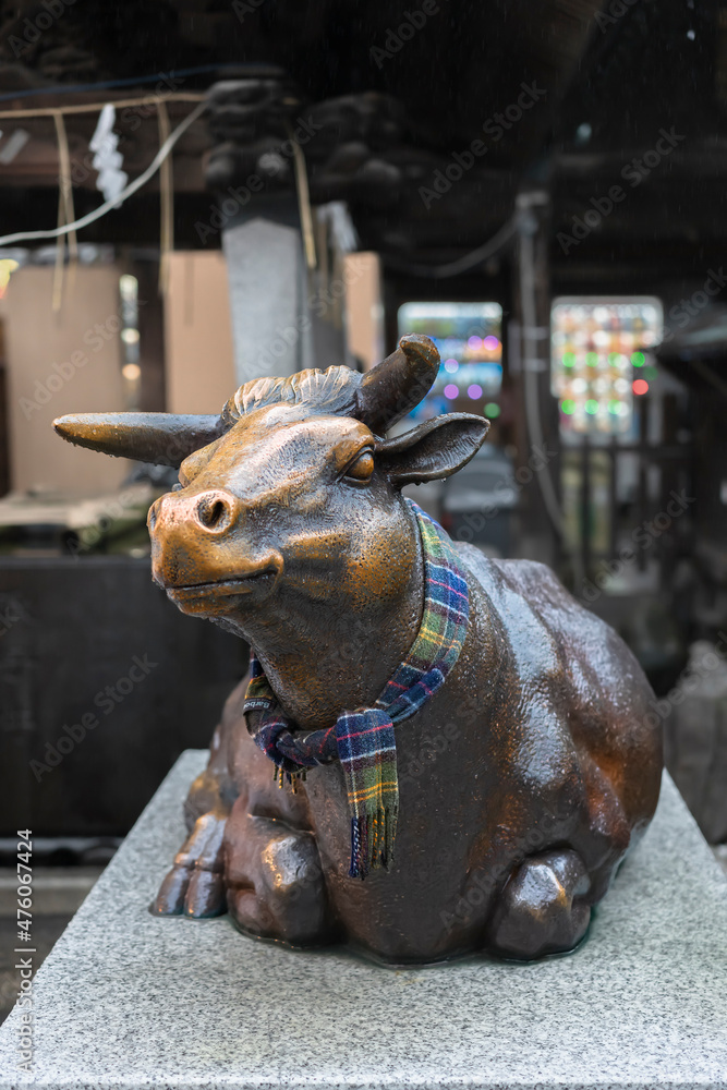 tokyo, japan - november 23 2021: Close up on a bronze statue of ox ...