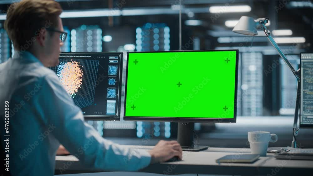High-Tech Data Center Server: Male IT Specialist Working on Green ...