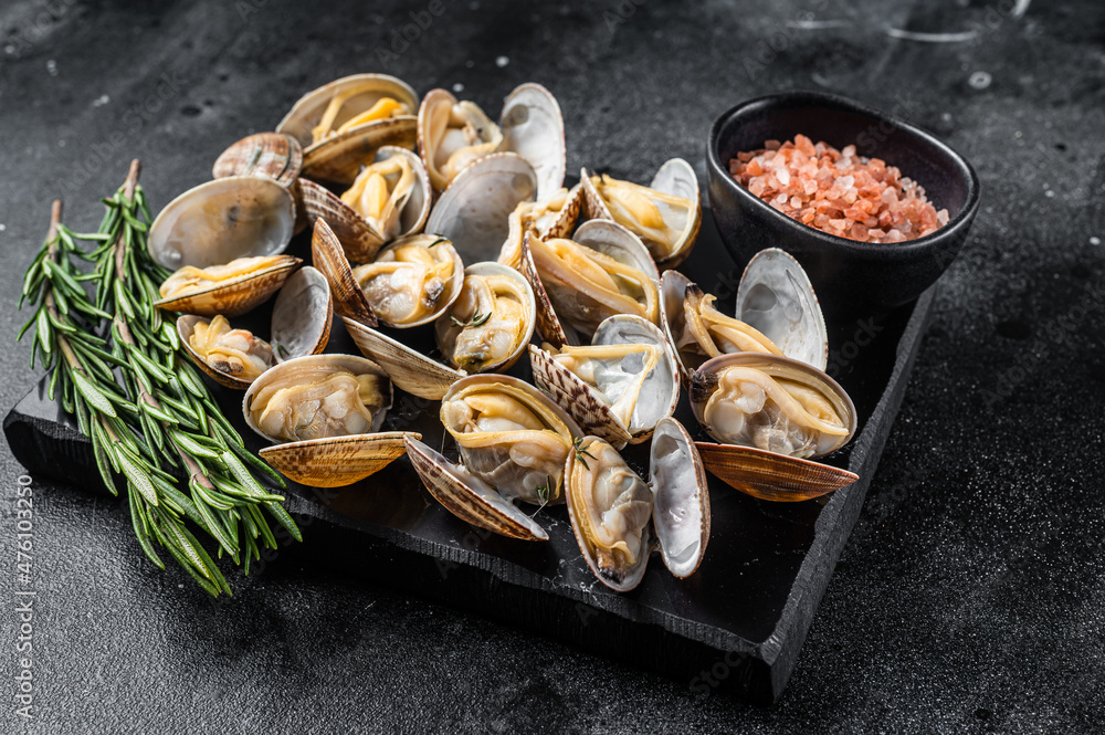 Steamed shellfish Clams with garlic and herbs. Black background. Top ...
