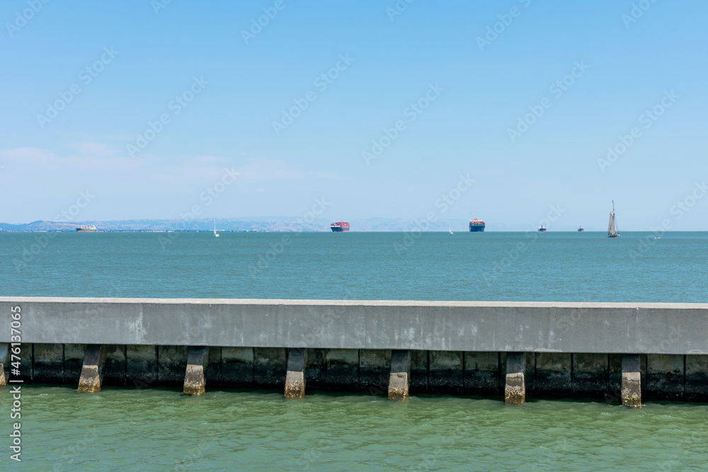 Concrete harbor wave barrier in San Francisco Bay. Blurred container ...