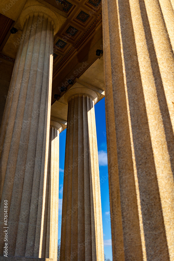 Three supporting columns in an ancient greek architectural style ...