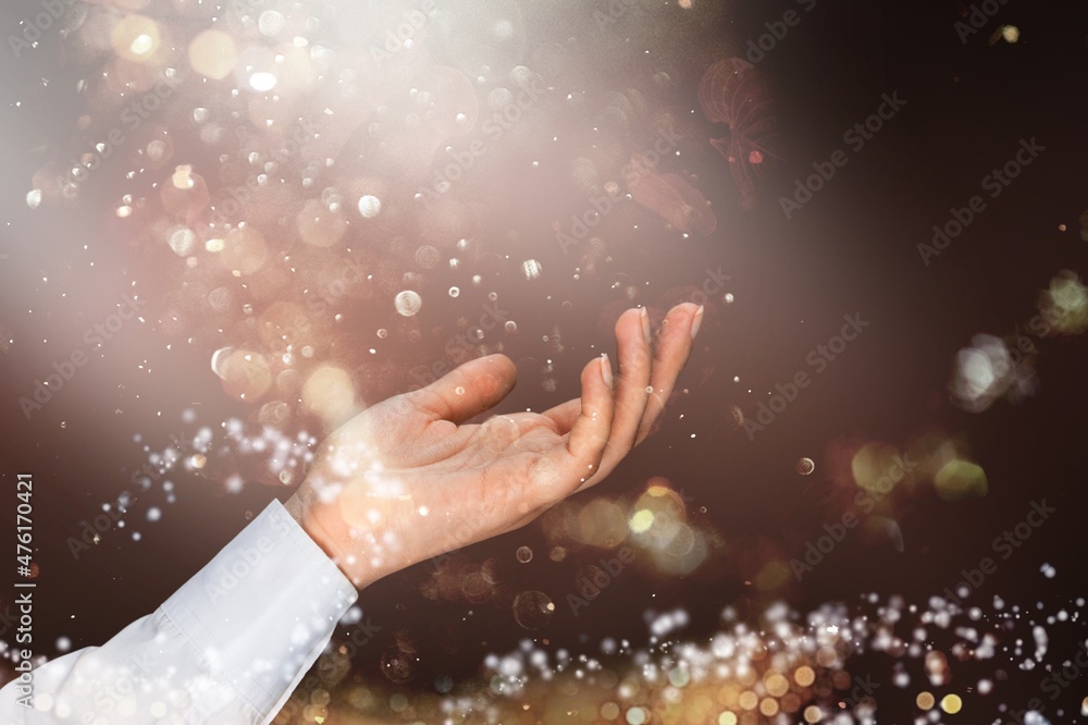 Stardust and magic in your hands. Magic particles on the palms of a ...