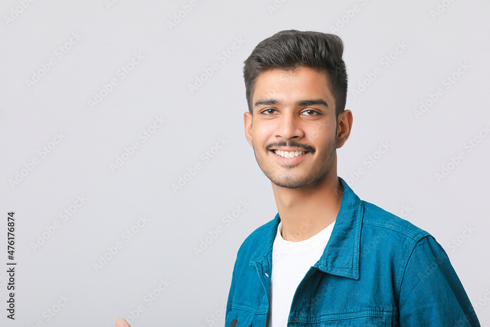 Young indian man wear jacket and giving expression over white ...