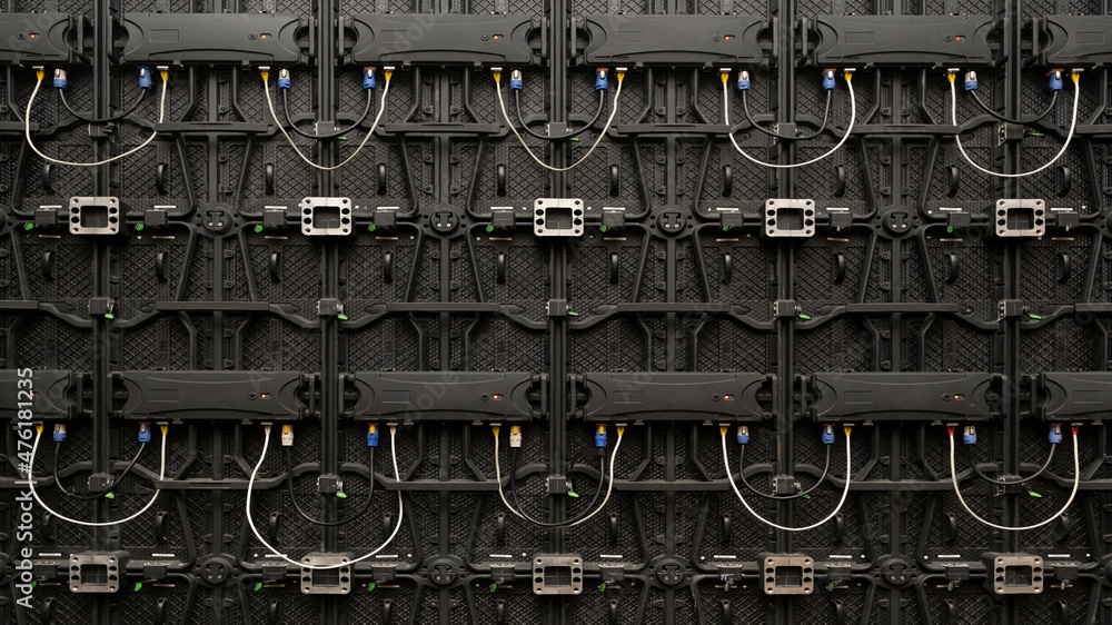 Backside of big LED screen monitor display. Power input and output wire ...