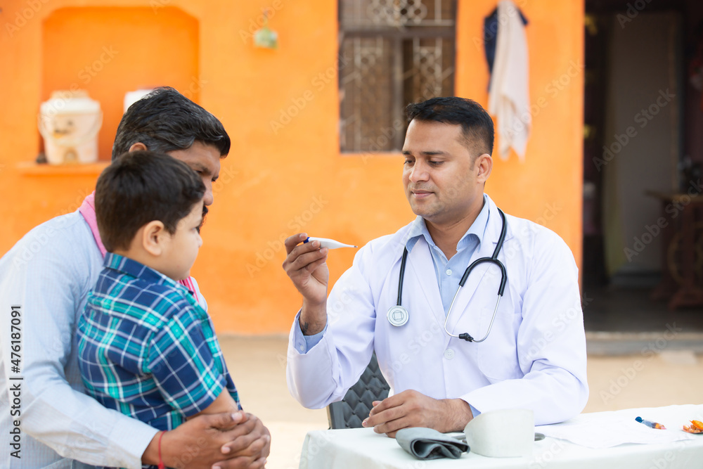 Indian Doctor examine little kid boy patient fever at village with ...