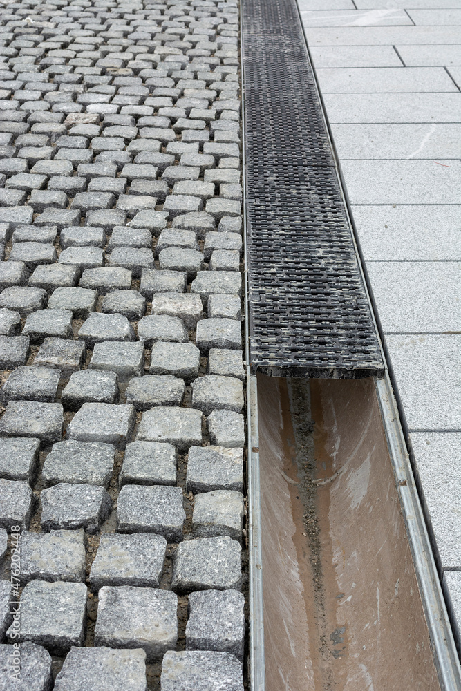paved streets on both sides, different paving and stormwater drainage ...