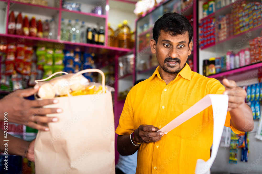 Shocked customer at Kirana or grocery store after seeing groceries bill ...