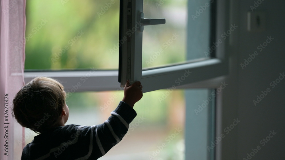 Little boy closing window. Child closes open window Stock Photo | Adobe ...