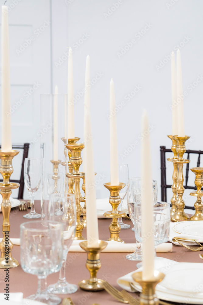 Beautiful candle tablescape with golden candle holders Stock Photo ...