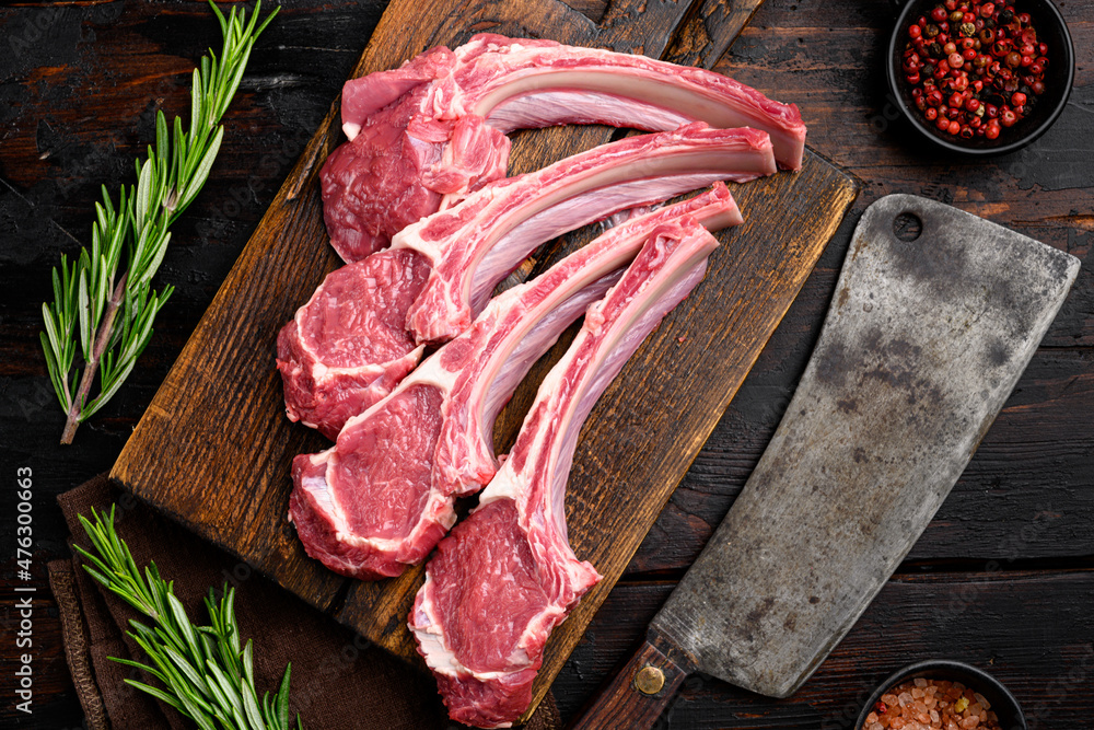 Raw Rack and rib chops of lamb, mutton, on old dark wooden table ...