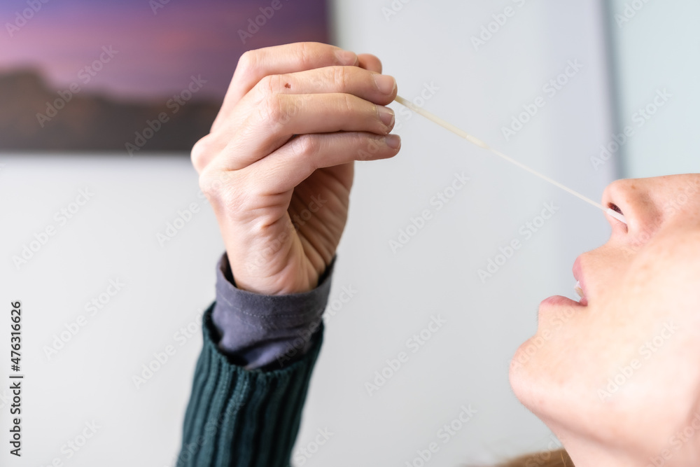 Detail of the nasal self test at your home. A young woman doing the ...