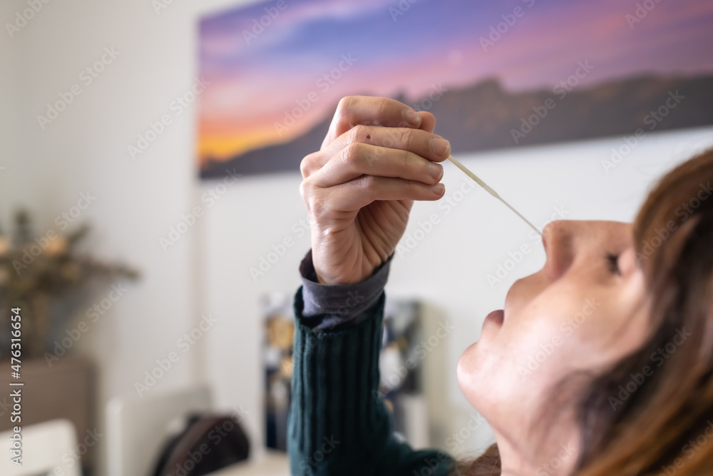 Detail of the nasal self test at your home. A young woman doing the ...