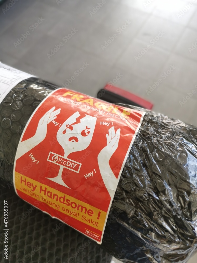 Packaging label sticker indicating fragile item that should be handle ...