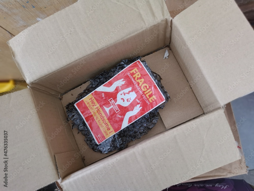 Packaging label sticker indicating fragile item that should be handle ...