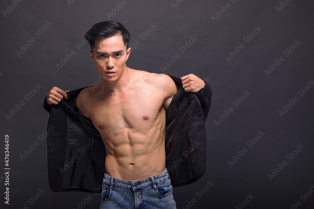 Strong, fit and handsome asian young man over black background Stock ...