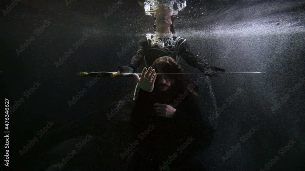 mysterious woman is giving magic sword to man floating underwater ...