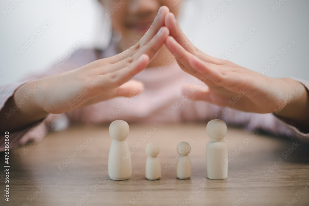 Protecting Hands Over wooden Family, Family Protection And Care Concept ...