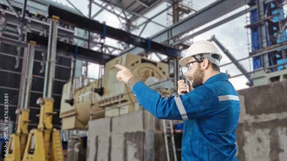 Engineer wearing safety helmet and high visible vest using walkie ...
