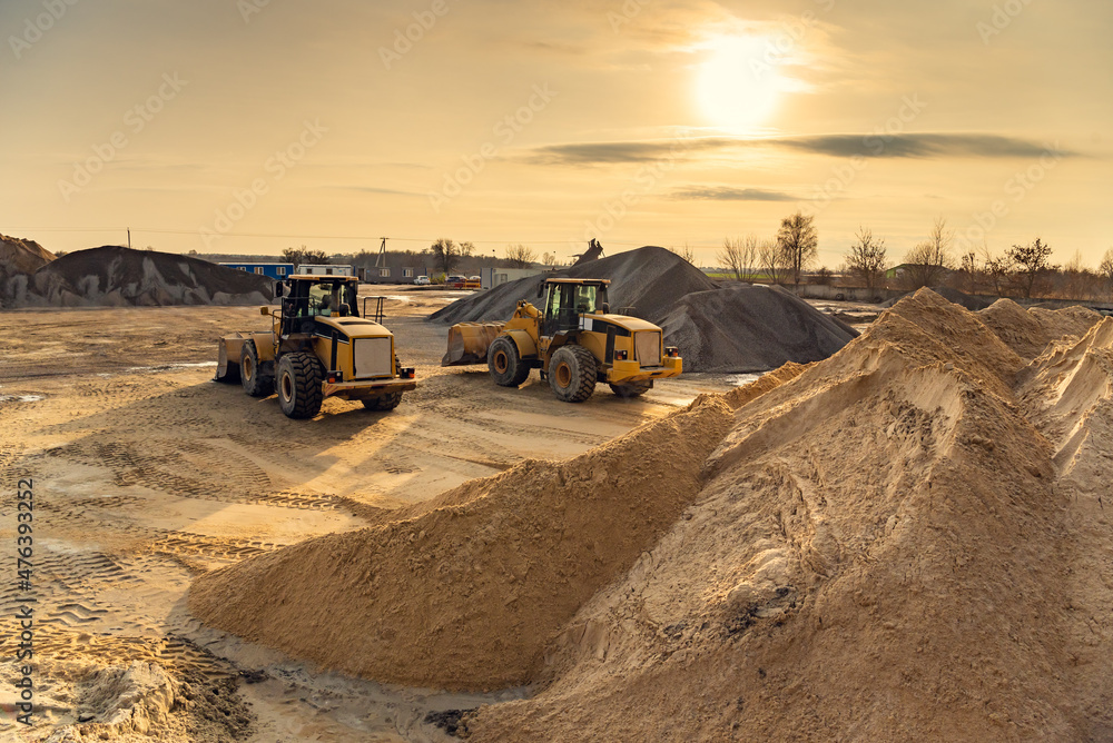 Loaders at a warehouse for building materials for concrete production ...