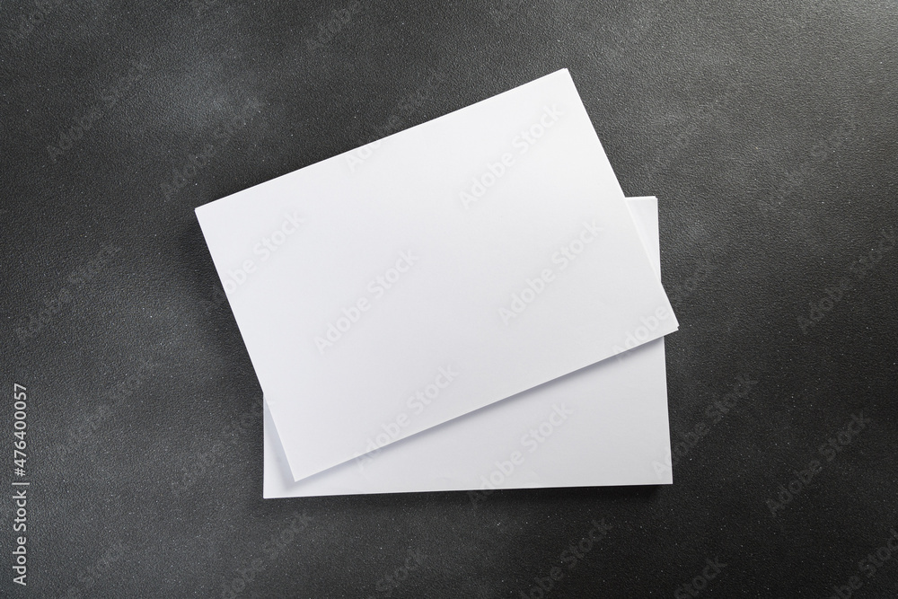 White business card sheet of paper a4 stack on a dark table. Clean ...