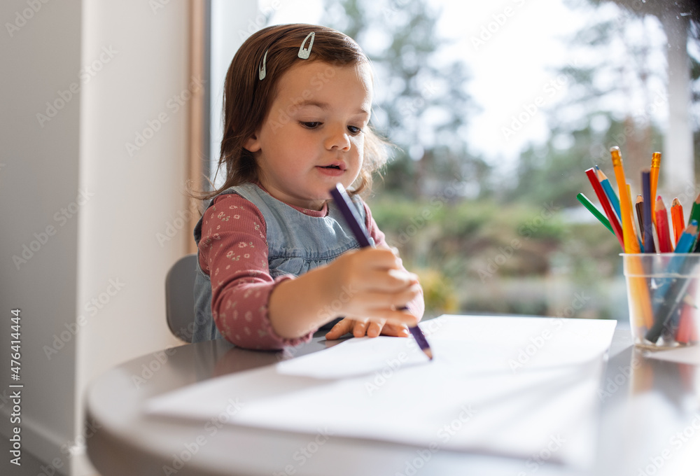 childhood, hobby and leisure concept - little girl drawing picture with ...