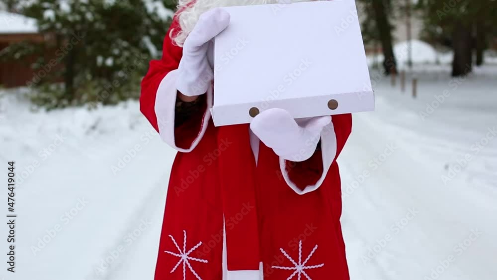White pizza box open in hands of Santa Claus in white mittens, with ...