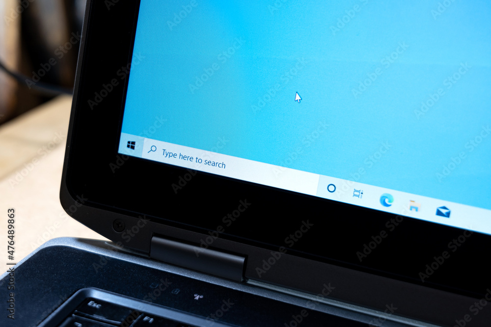 Microsoft Windows 10 OS logo on laptop task bar, search bar, start menu ...