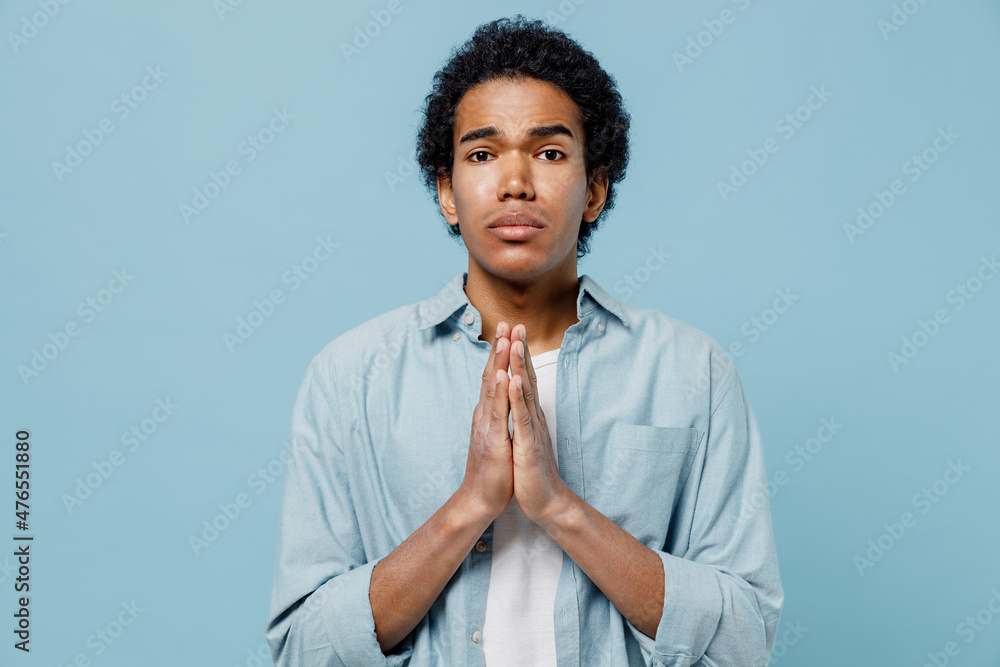 Pleading young black curly man 20s years old wears white shirt hands ...