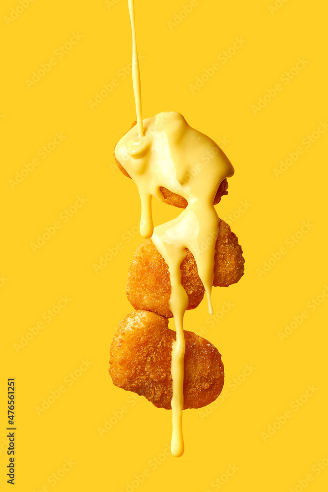 Levitating chicken nuggets topped with cheese sauce. Flying nuggets ...