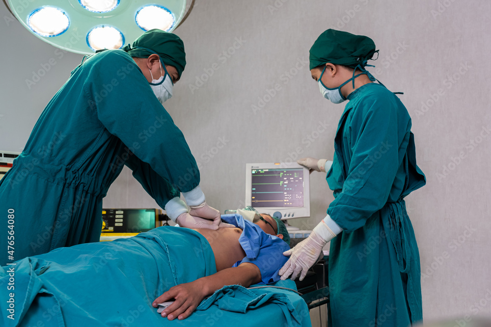 Selective focus at defibrillator while doctor use it to pump at chest ...