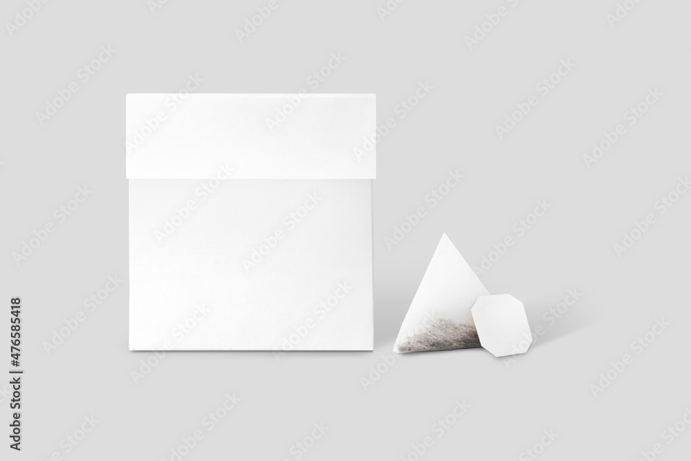 Blank tea bags with label tag and dried leaves inside. Tea box ...