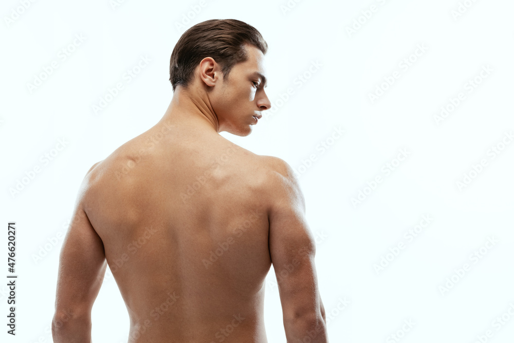 Back view of young handsome shirtless man posing isolated on white ...