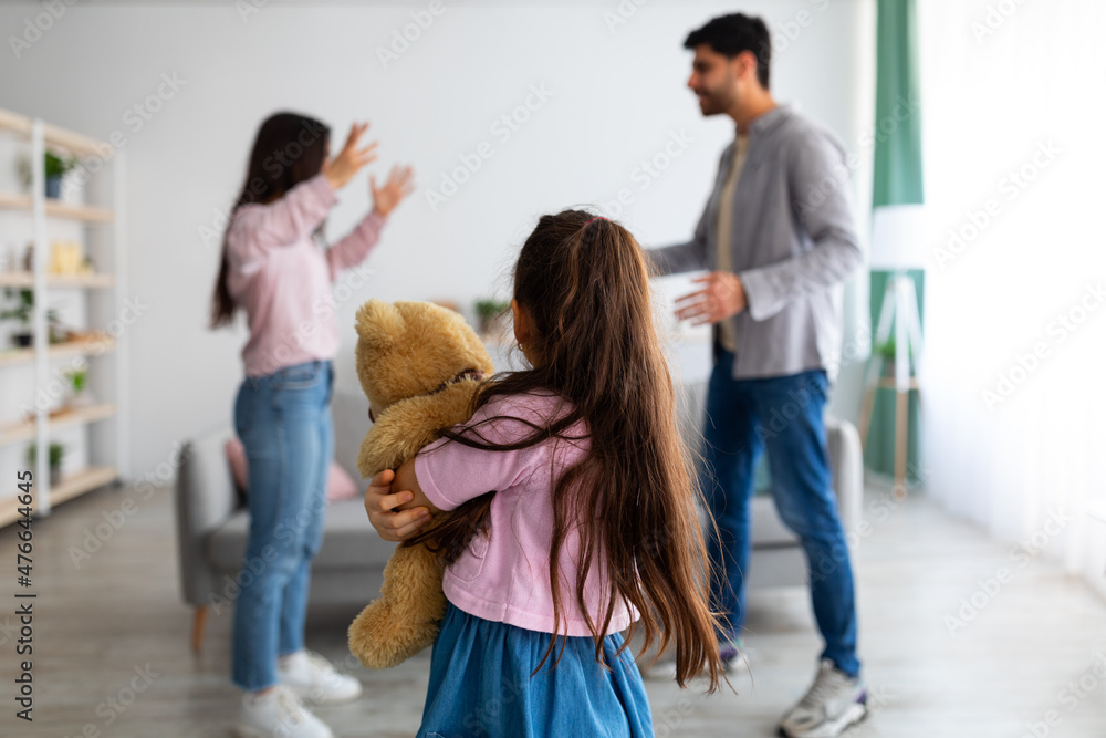 Family quarrels concept. Little girl suffering from family quarrels ...