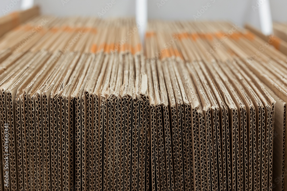 Stack of corrugated cardboard for packaging. Detail of uneven stack of ...