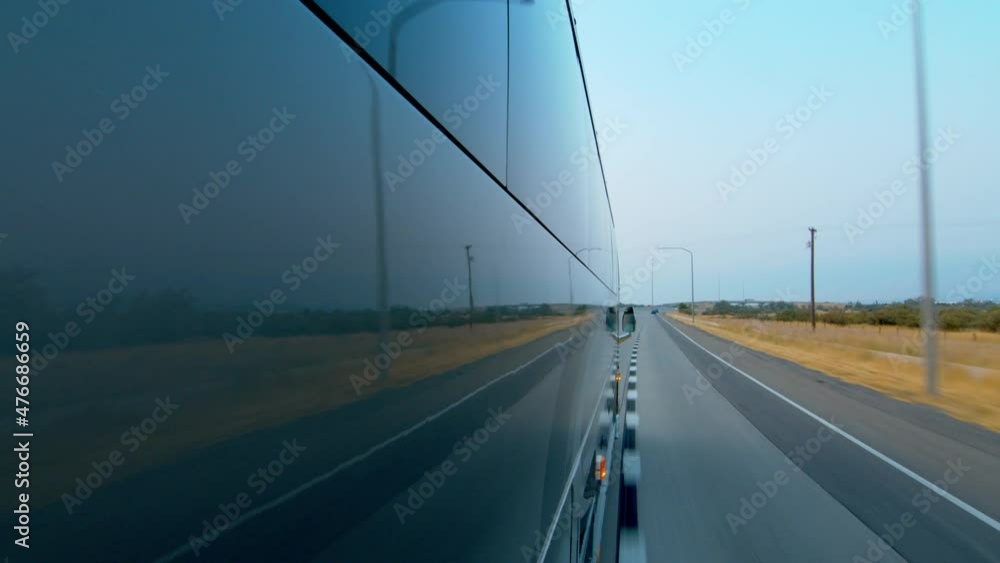Side view of a public bus, shuttle, or school bus driving and the road ...