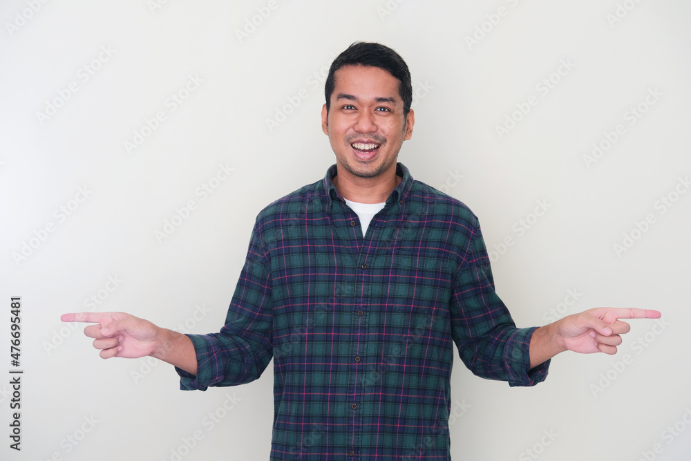 Adult Asian man pointing to the left and right with happy face ...