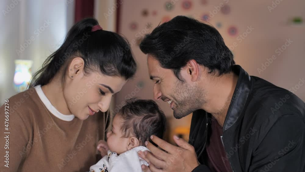 Young Indian parents hugging and cuddling with their adorable daughter ...
