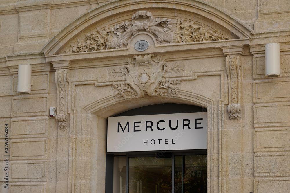 mercure hotel text brand and sign logo on door entrance building facade ...