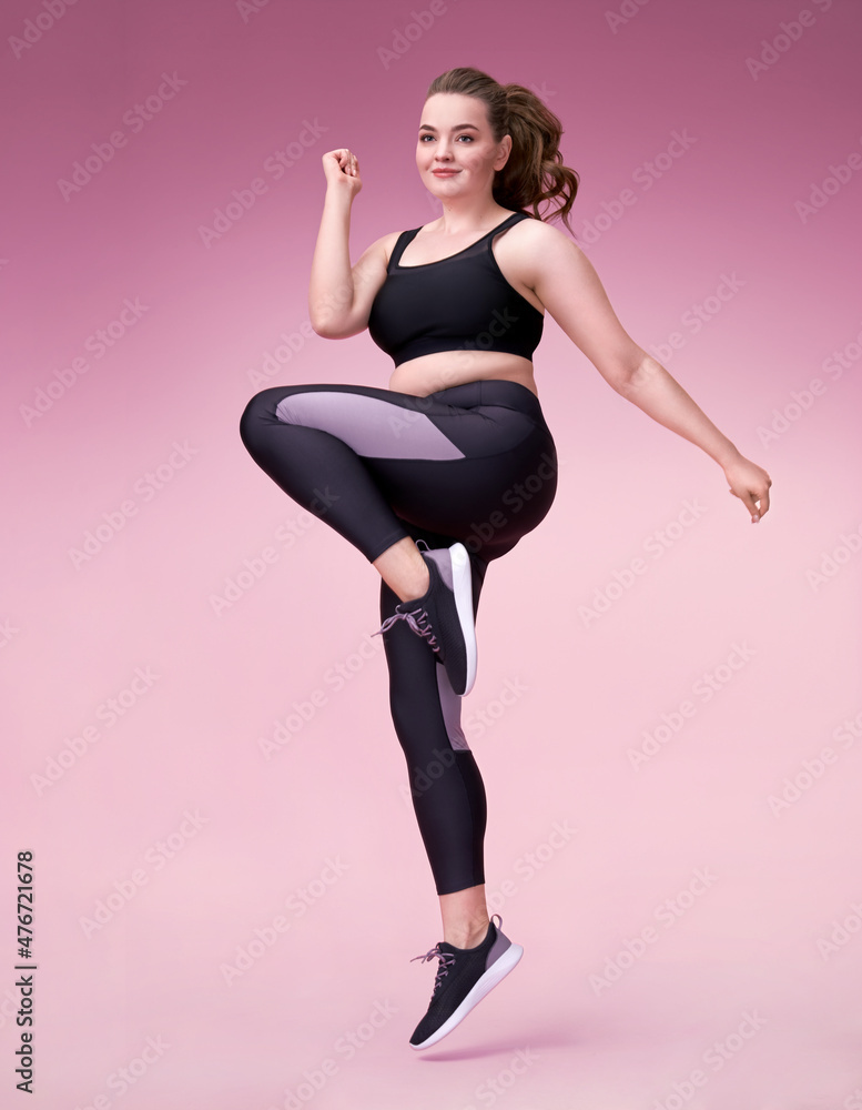 Sporty girl jumping, doing exercise. Photo of model with curvy figure ...